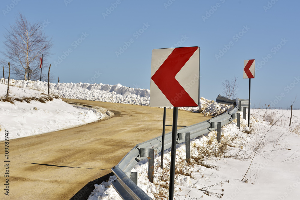 road signs indicating direction on curved road Stock Photo | Adobe Stock