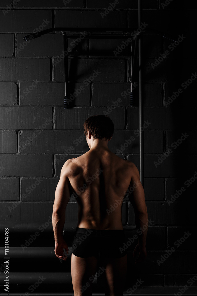Athlete muscular fitness male model pulling up on horizontal bar ...