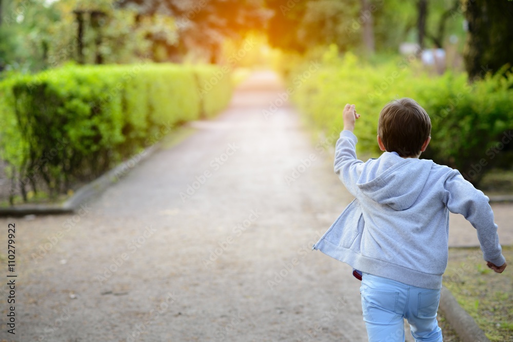 Little boy running in the park. Back view Stock Photo | Adobe Stock