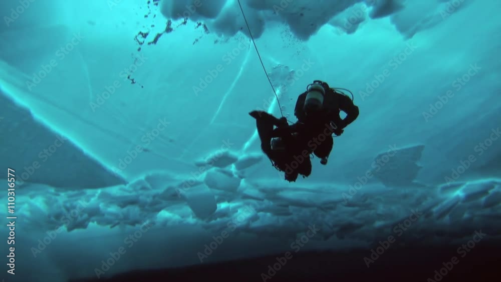 Unique extreme underwater shooting scuba dive beneath ice at geographic ...