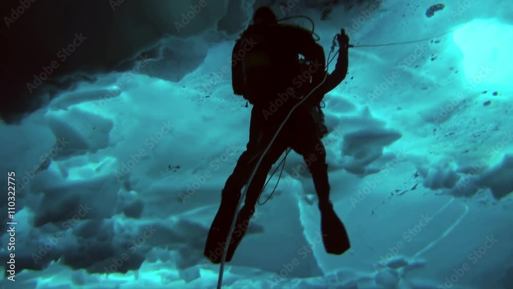 Unique extreme underwater shooting scuba dive beneath ice at geographic ...