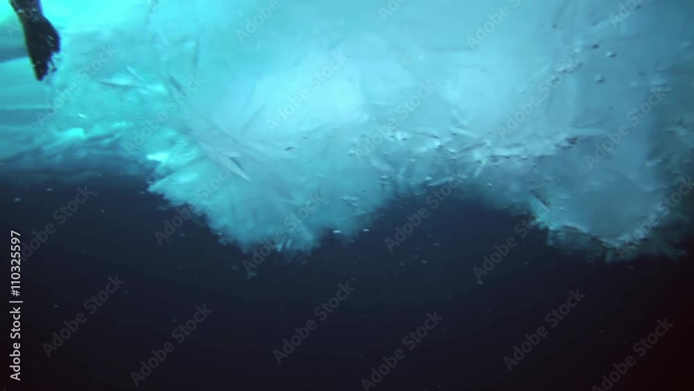 Unique extreme underwater shooting scuba dive beneath ice at geographic ...
