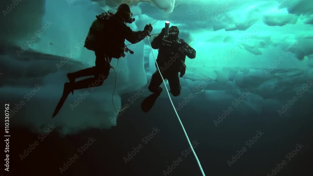 Unique extreme underwater shooting scuba dive beneath ice at geographic ...