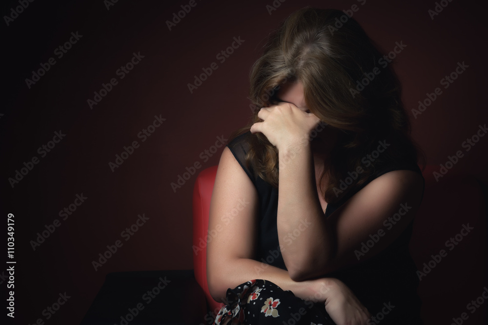 Crying sad woman on a dark background Stock Photo | Adobe Stock