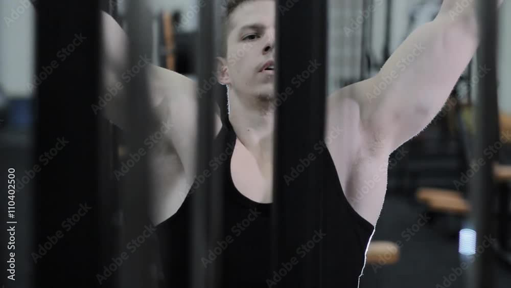 Handsome young guy with big muscles, trains the chest. Excellent ...