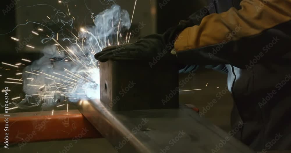 Connecting the square metal on the metal bar using a welding machine ...