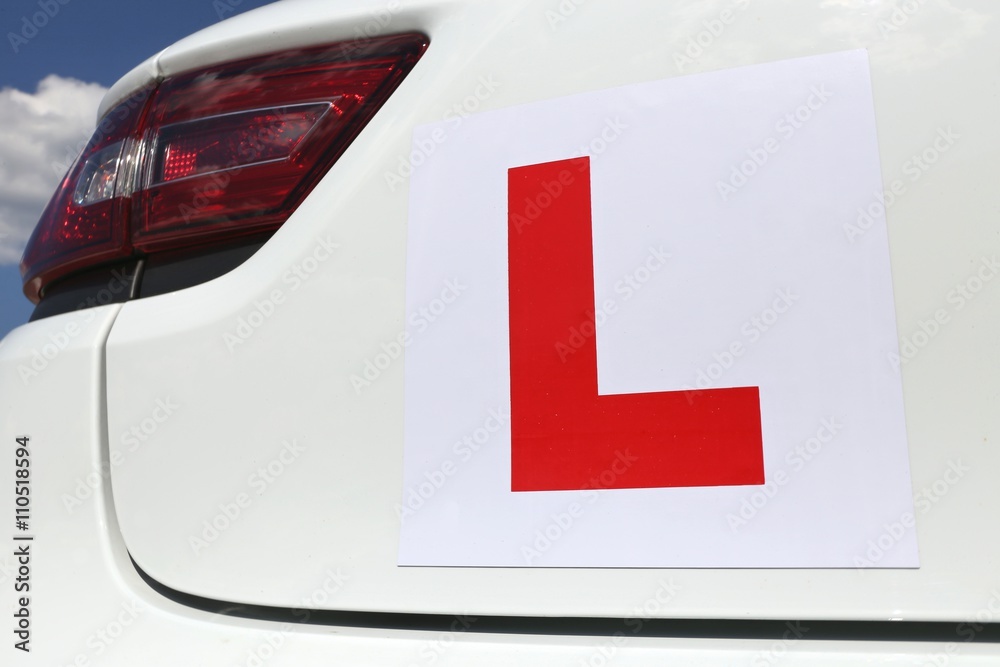 magnetic British L-plate affixed to the back of a white car Stock Photo ...