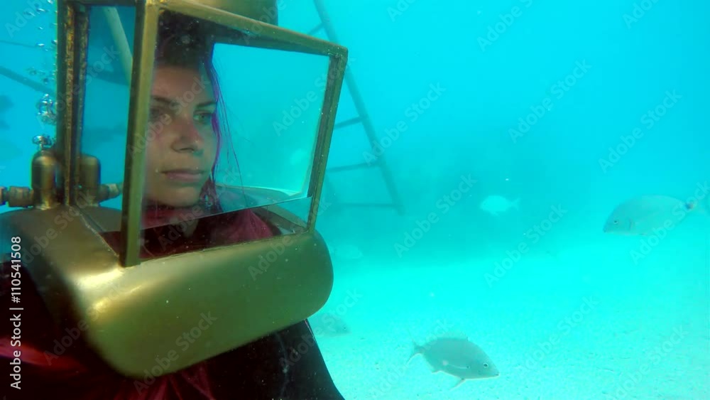 Girl in the helmet looks at sea creatures at the Bermuda Helmet Diving ...