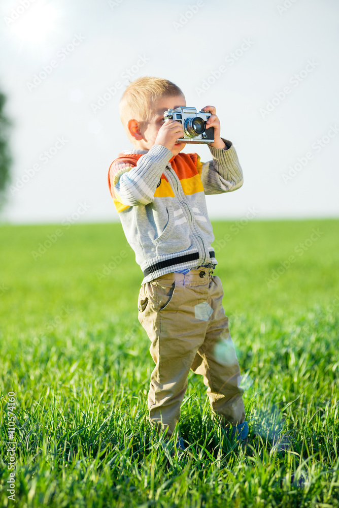 Little boy with an old camera shooting outdoor. Kid taking a photo ...