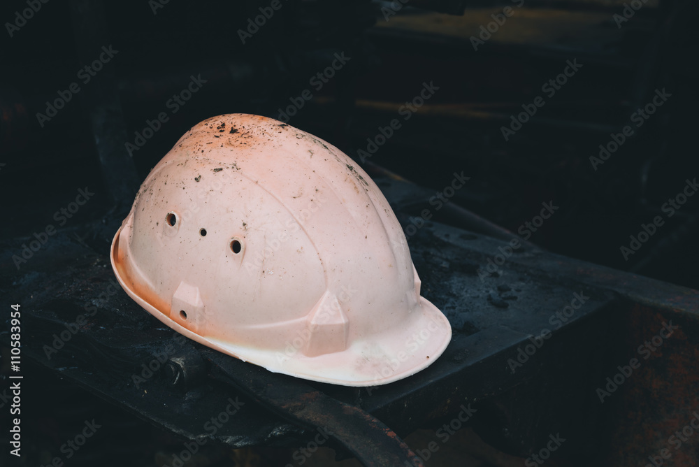 old abandoned safety helmet on a black background Stock Photo | Adobe Stock