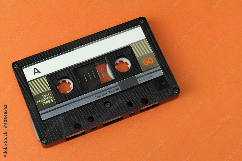 Audio Compact Cassette C60 tape with a blank label on a colored ...