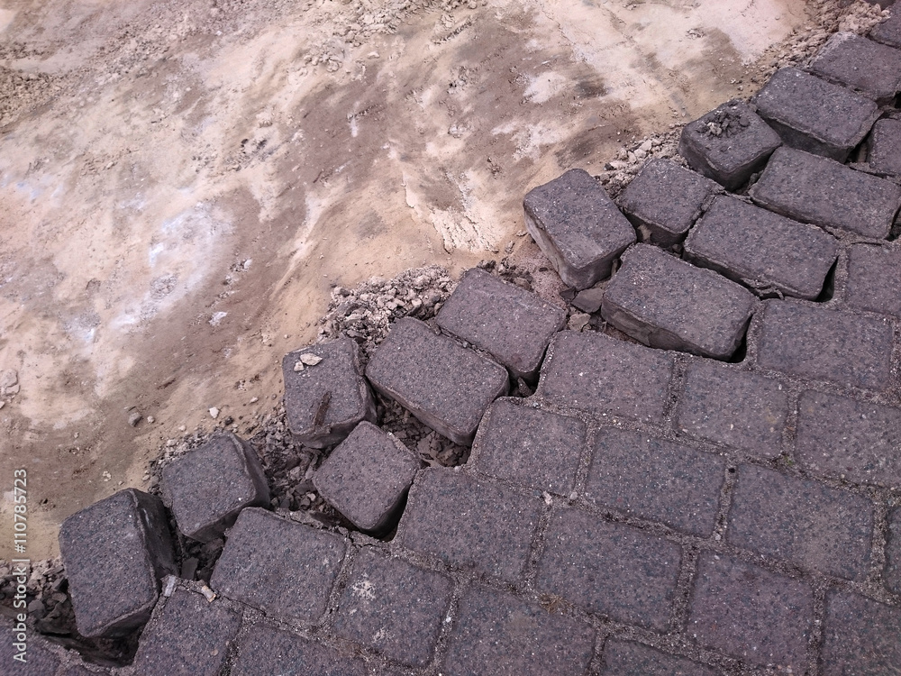 brick pavement dissolving diagonally into sand foto de Stock | Adobe Stock