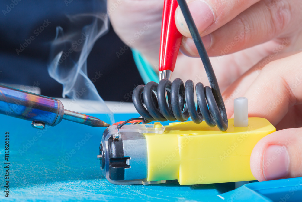 Soldering wires to electric motor Stock Photo | Adobe Stock