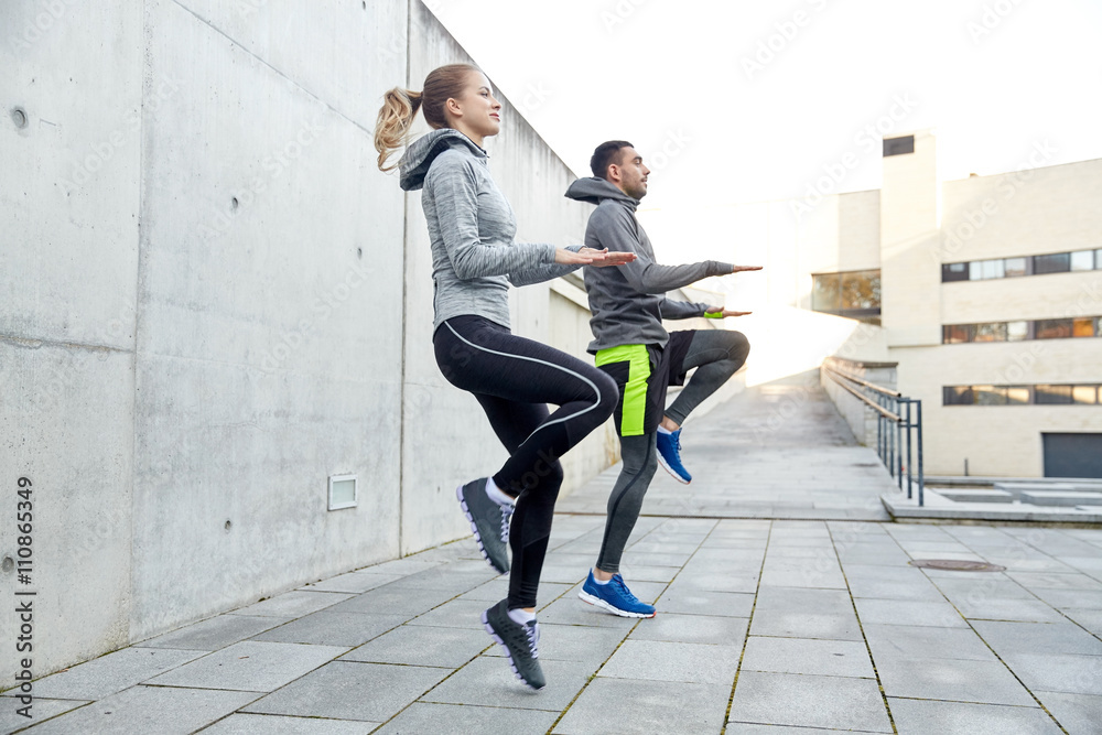 happy man and woman jumping outdoors Stock Photo | Adobe Stock