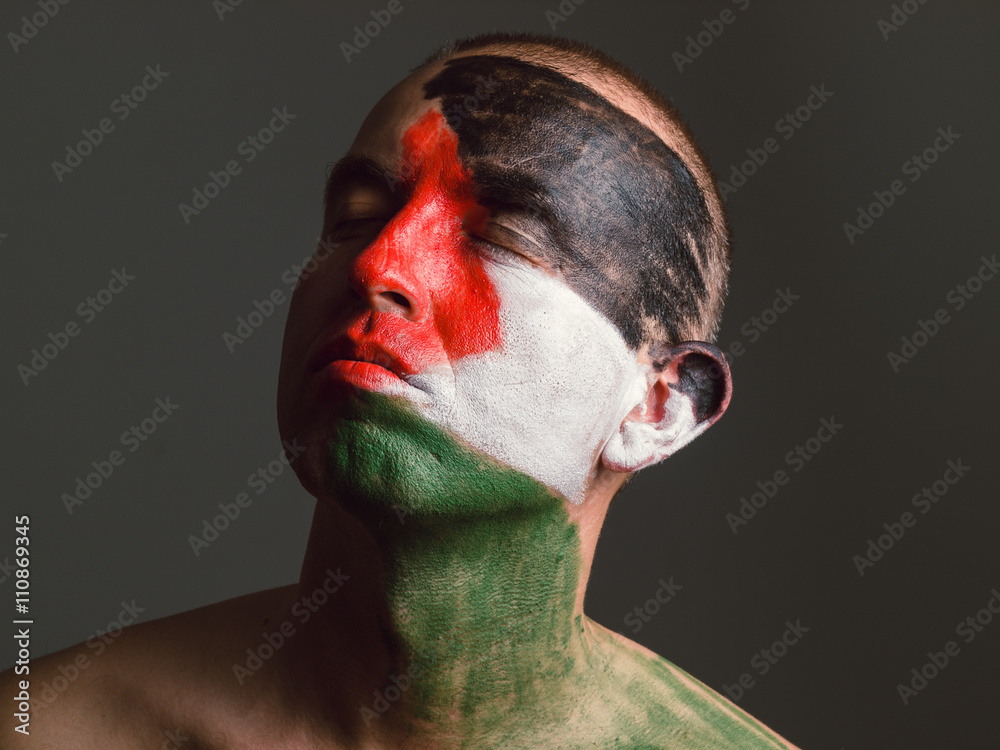Man with his face painted with Palestinian flag. Stock Photo | Adobe Stock
