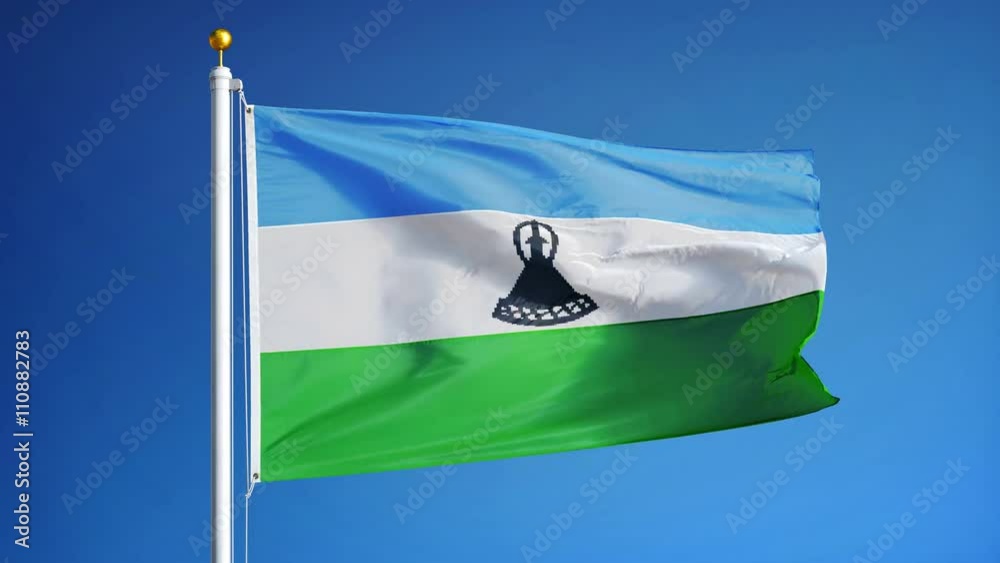 Lesotho flag waving in slow motion against clean blue sky, seamlessly ...