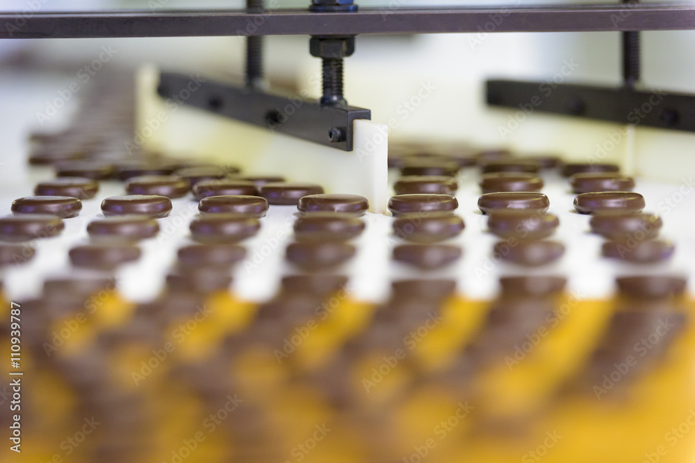 Chocolates on production line in chocolate factory Stock Photo | Adobe ...