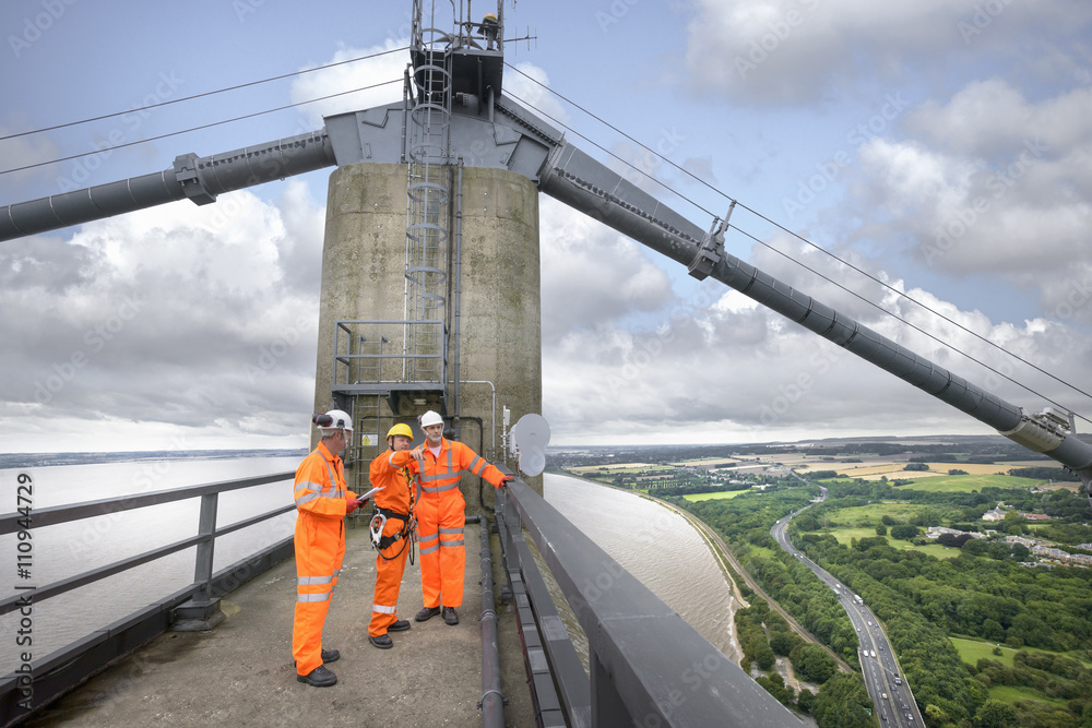 Bridge workers on top of suspension bridge. The Humber Bridge, UK was ...