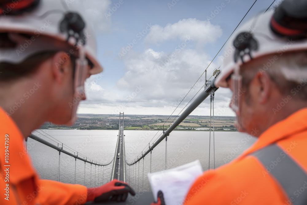 Bridge workers on top of suspension bridge. The Humber Bridge, UK was ...