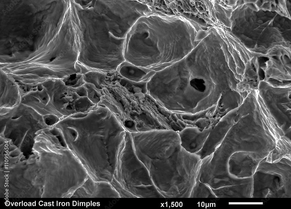 Cast Iron fractured surface. Dimple overload with inclusions imaged in ...