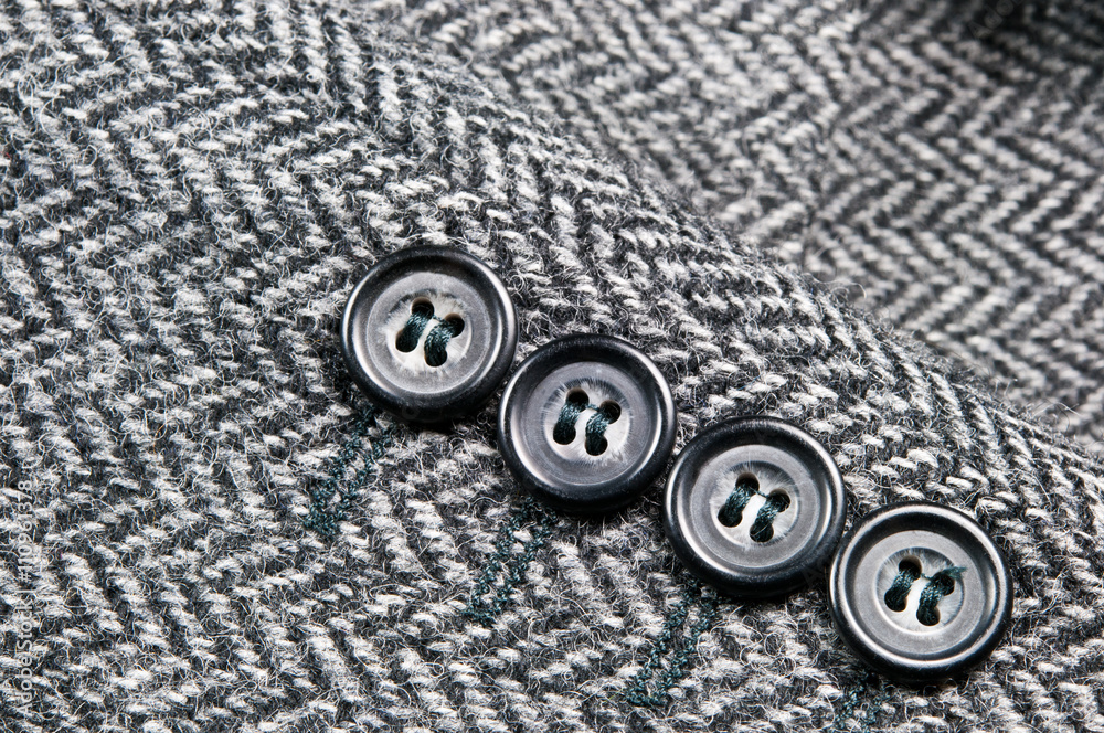 buttons in a row on a wool jacket. buttons placed diagonally across ...