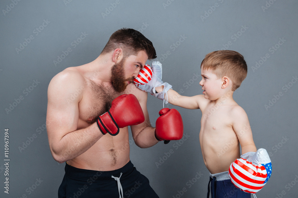 Dad and son playing using boxing gloves together Stock Photo | Adobe Stock