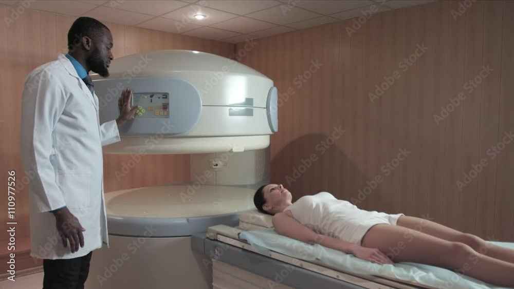 Open mri scanning procedure. Female mri patient and male african ...