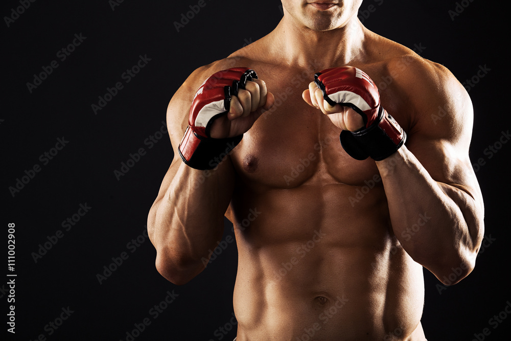 Strong Athletic Man showing muscular body on a black background ...