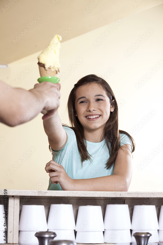 Girl Receiving Vanilla Ice Cream Cone From Waiter Stock Photo | Adobe Stock