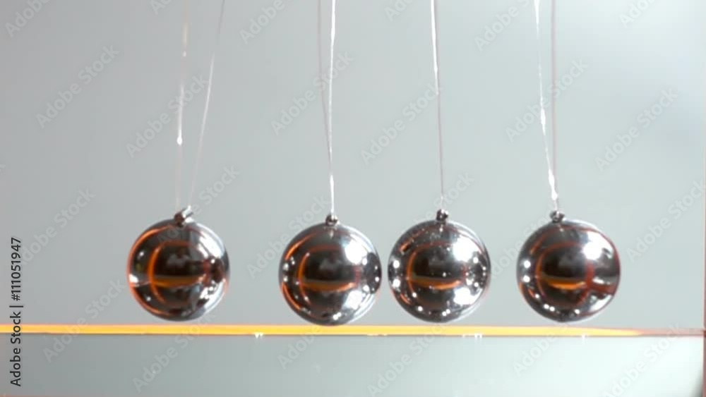 Newton's Cradle with silver balls. Slow motion. Balancing balls Newton's Cradle physics concept ...