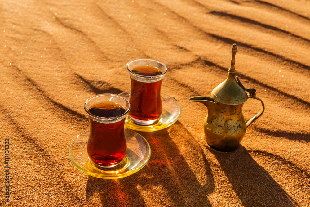 Arabic tea in traditional glasses and pot on desert at sunset Stock ...