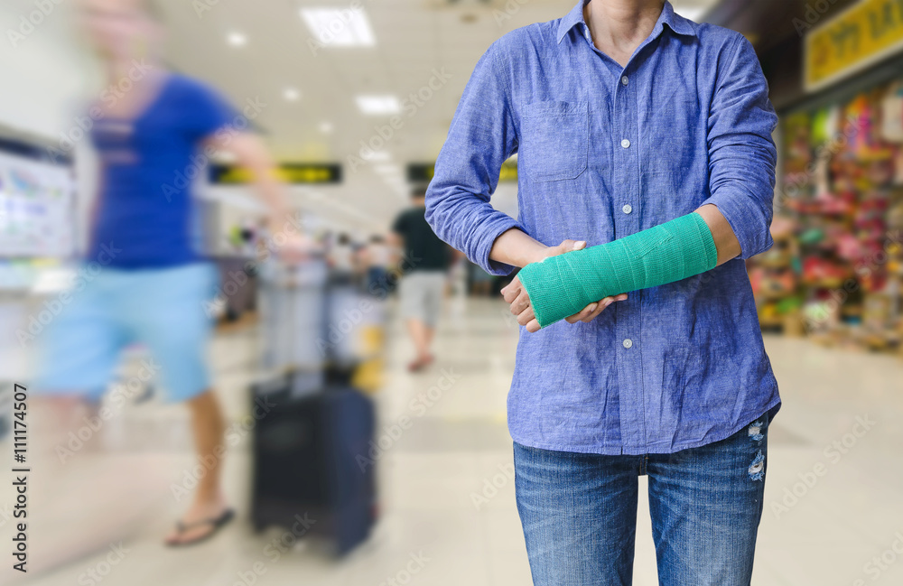 Injured woman with green cast on hand and arm on traveler in mot Stock ...