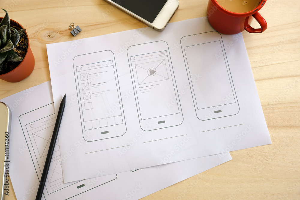 Designer desk with UI wireframe sketches Stock Photo | Adobe Stock