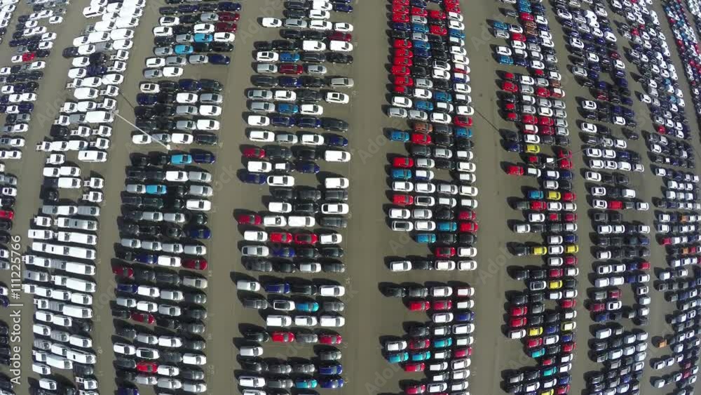 Aerial top down view reverse of new car storage parking lot showing ...