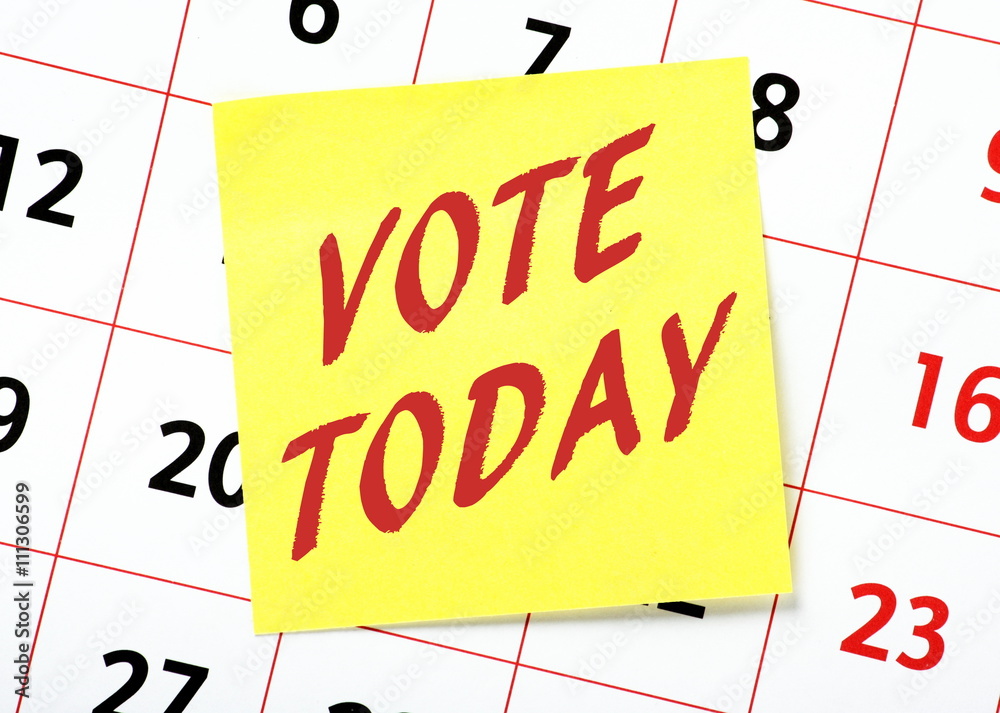 The words Vote Today written in red text on a yellow sticky note posted ...