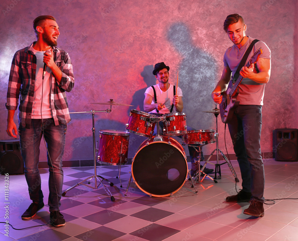 Musicians playing musical instruments and singing songs in a studio ...