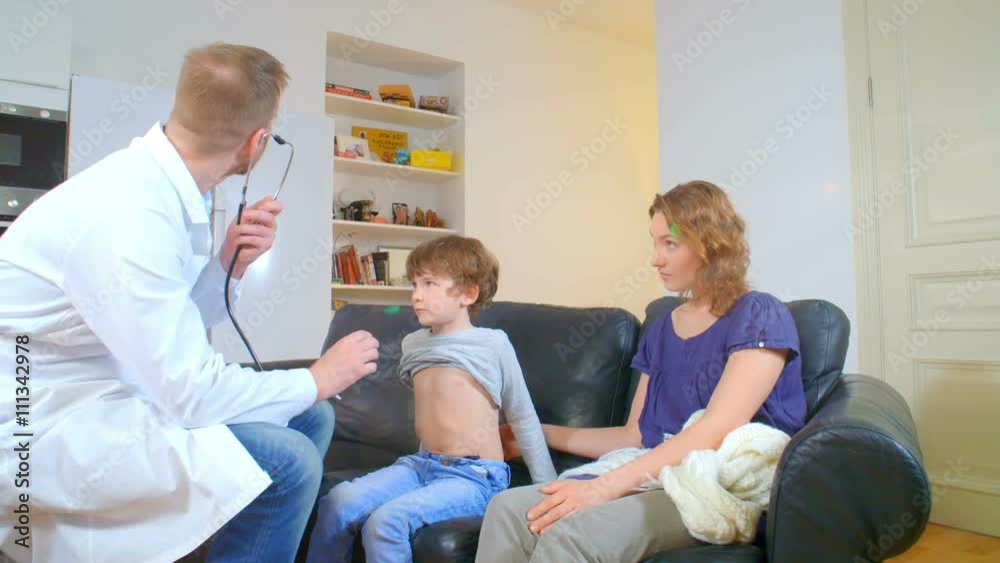 home doctor came to sick boy and his mother. he examines a child and ...