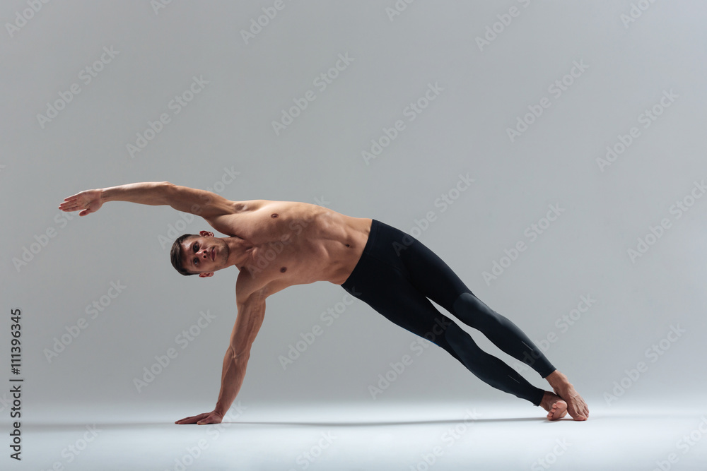 Fitness man doing stretching exercise Stock Photo | Adobe Stock
