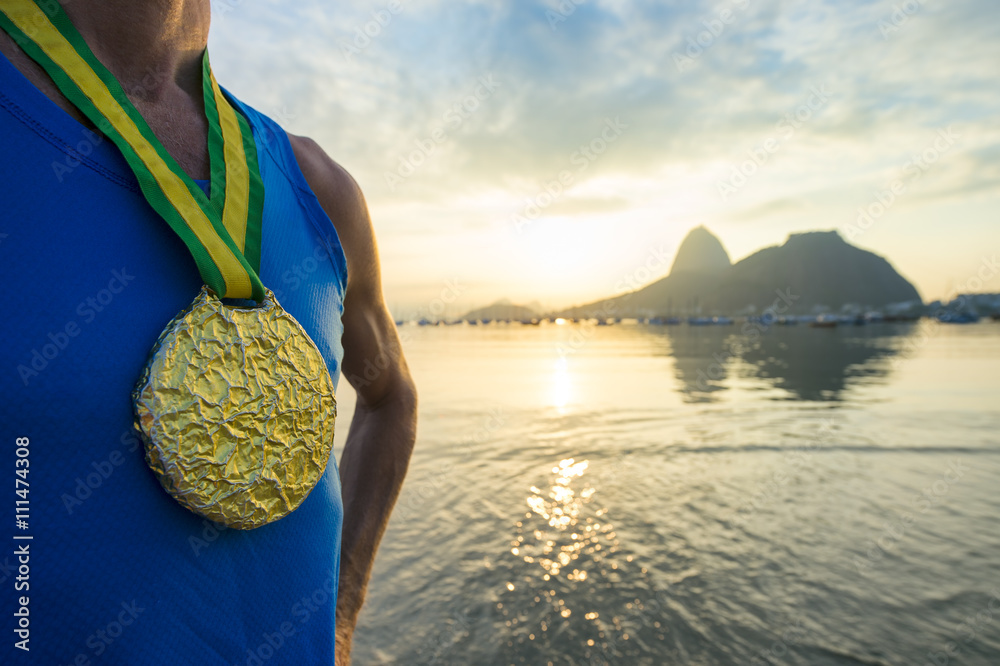 Gold medal champion athlete standing outdoors at the golden sunrise in ...
