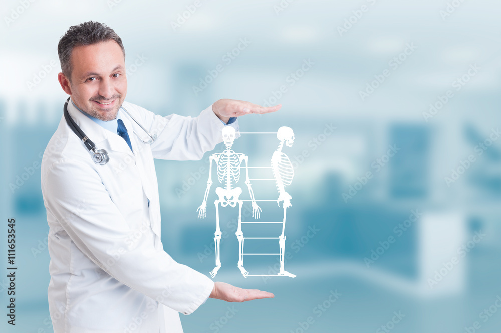 Handsome orthopedist doctor holding skeleton model hologram on h Stock ...