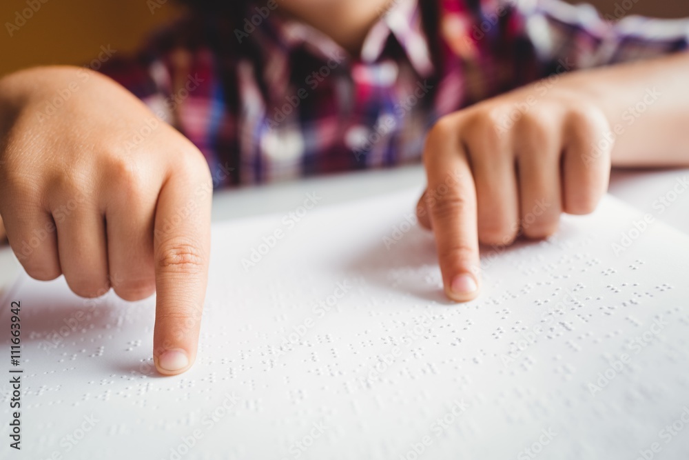 Boy using braille to read Stock Photo | Adobe Stock
