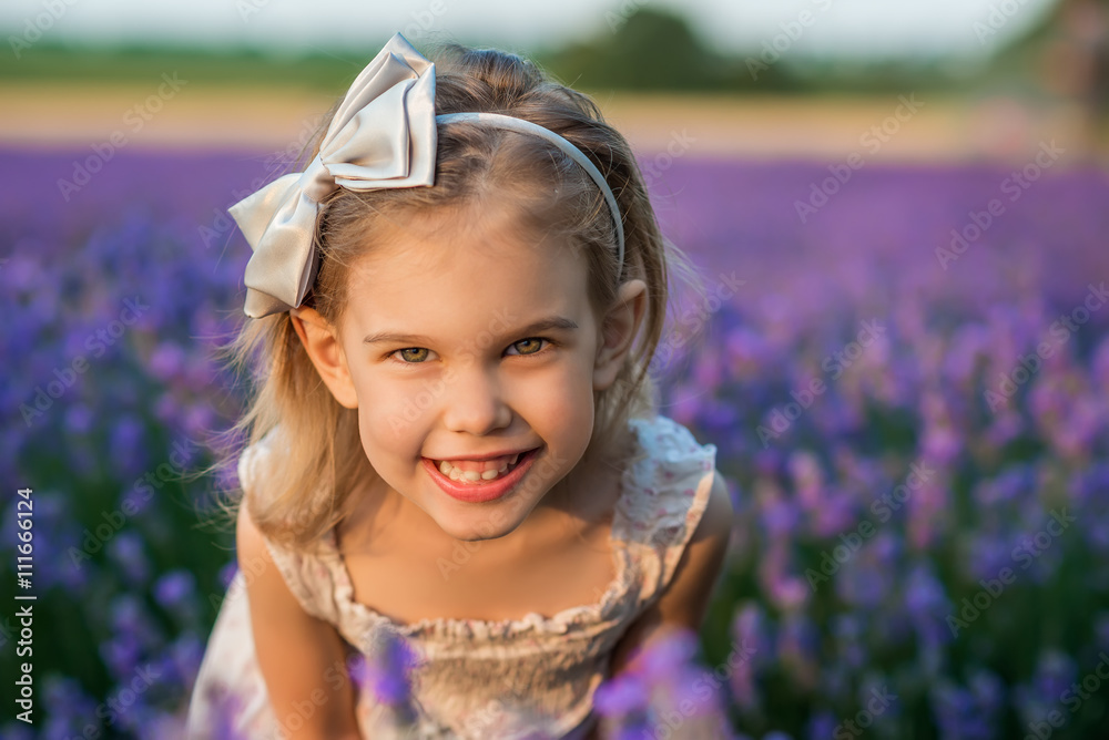 Beautiful little girl on the background of a lavender field at sunset ...