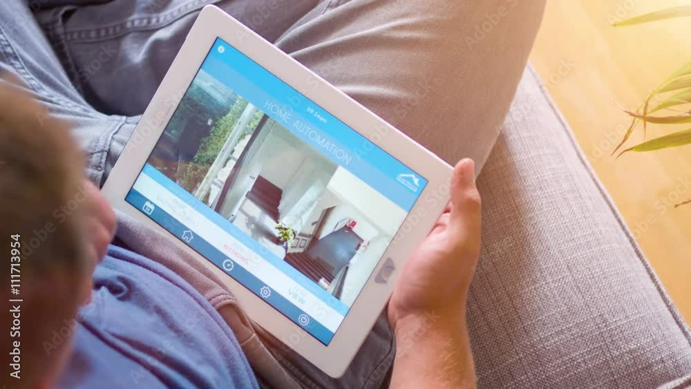 smart house, home automation, device with app icons. Man uses his ...