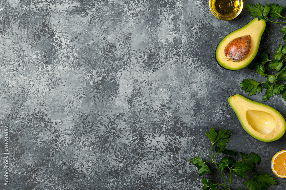 Food background with avocado, lemon, parsley and olive oil. Stock Photo ...