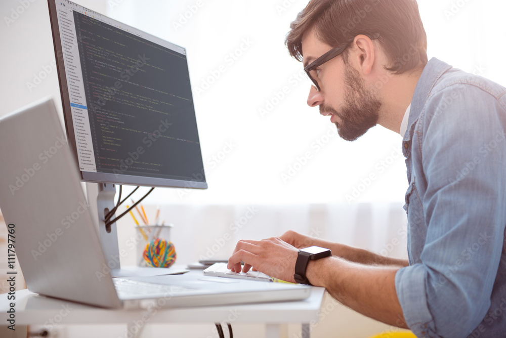 Man programming on his computer Stock-Foto | Adobe Stock