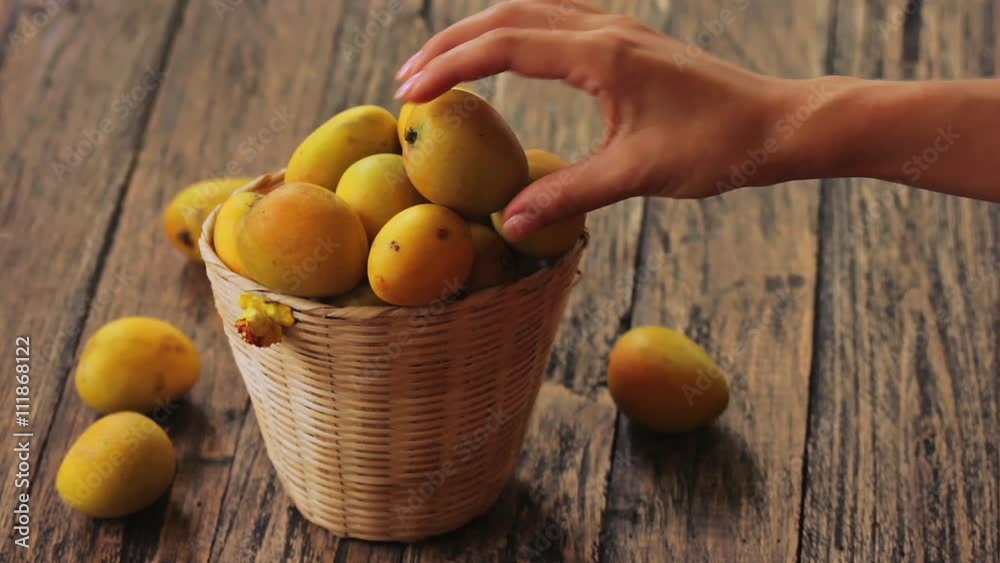 Female hand taking one mango from the basket with mangoes Stock Video ...