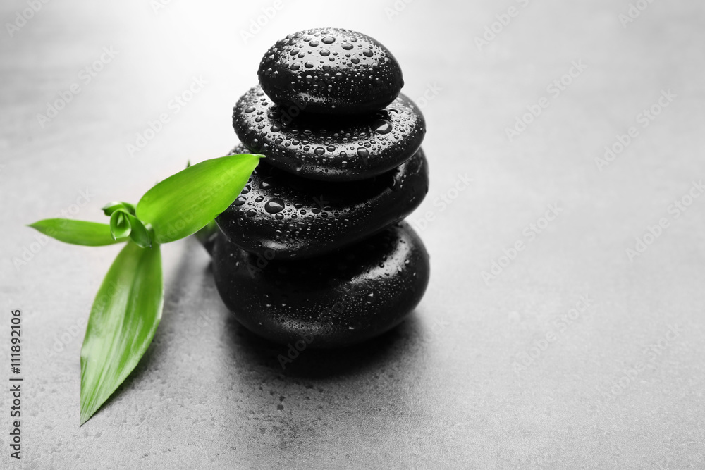 Heap of spa hot stones on grey background Stock Photo | Adobe Stock