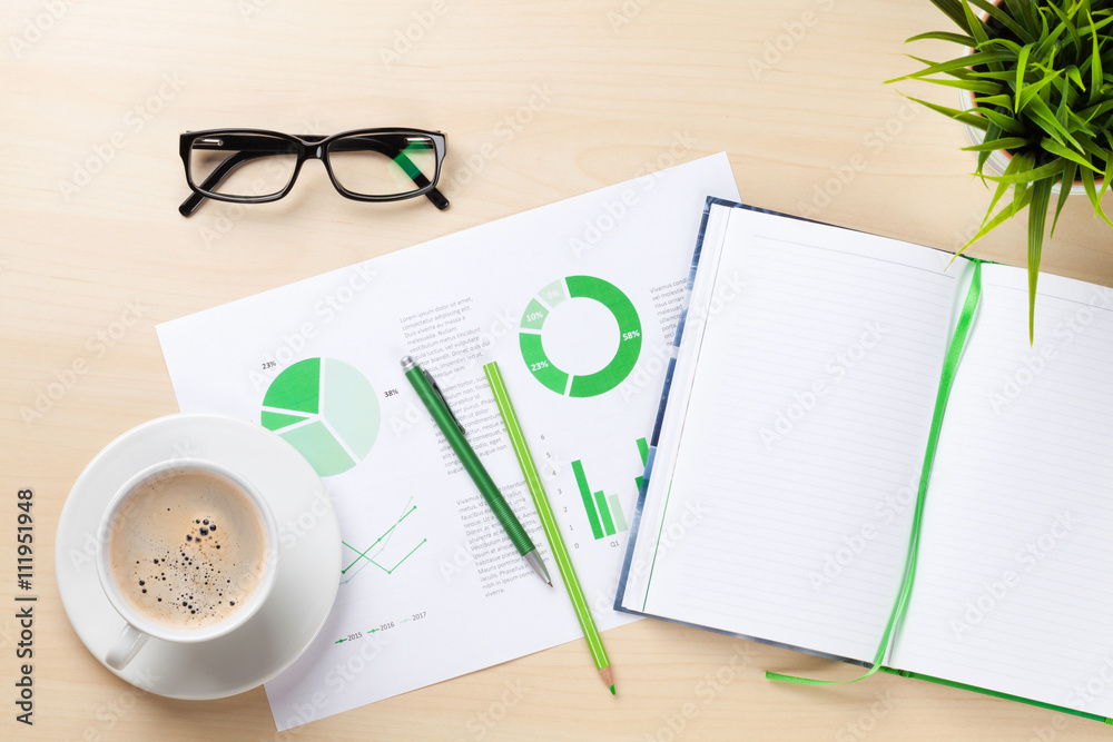 Office workplace with charts, plant and notepad Stock Photo | Adobe Stock