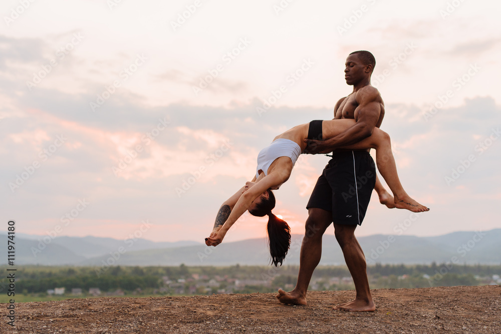 Beautiful dance. Mixed race gymnastic couple dancing on the pink ...