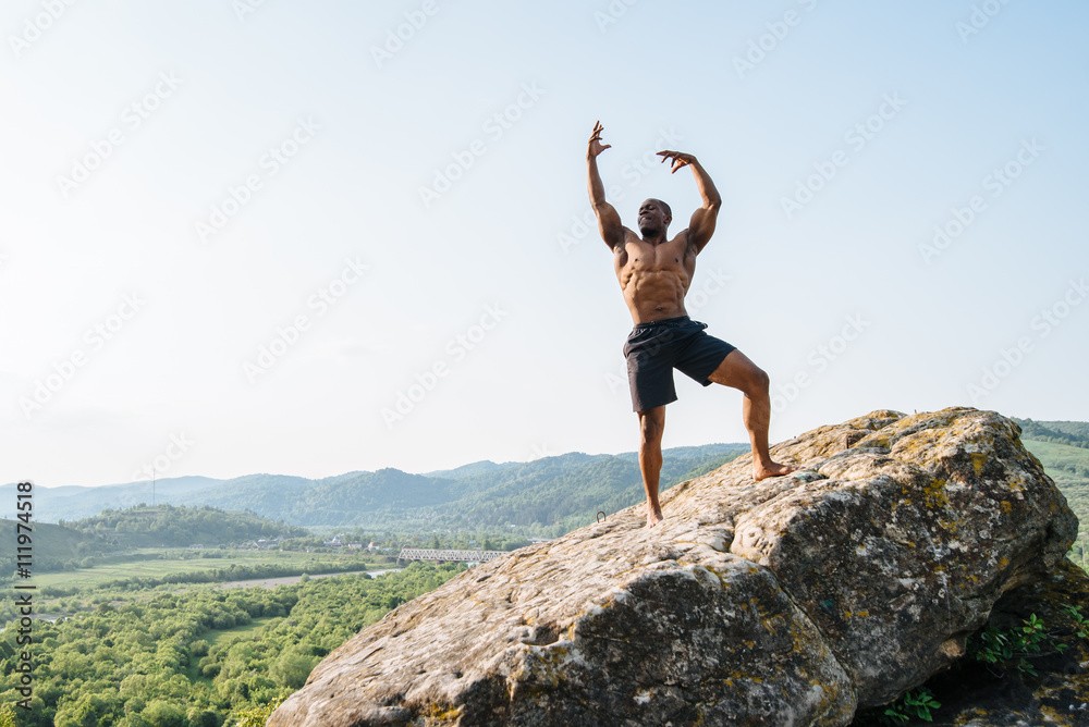 Emotional portrait of black african american athlete man on the rock in ...